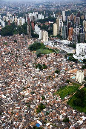 Aerial view of crowded favela housing contrasts with modern apartment ...