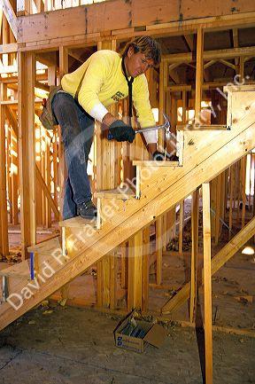 Carpenter building a stairs. | David R. Frazier Photolibrary, Inc.