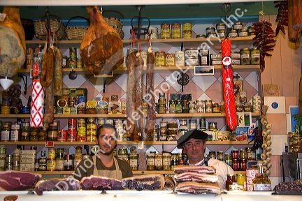 French Basque men working in a shop selling cheese and meats in the ...