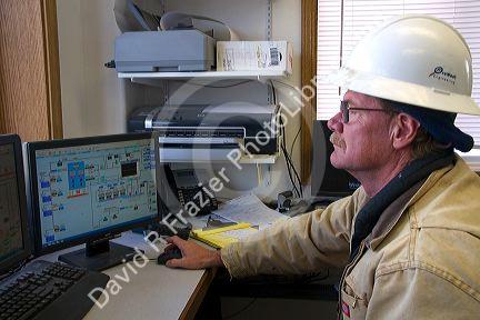 Operator using computers to monitar the system of a geothermal power ...