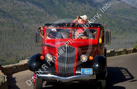 Red Jammer bus on the Going-to-the-Sun Road in Glacier National Park ...